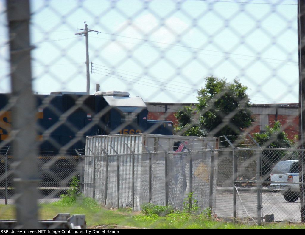 CSX 1562 hides behind the fence
